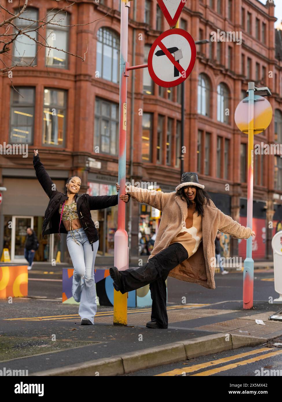 Two young women dancing in street Stock Photo - Alamy