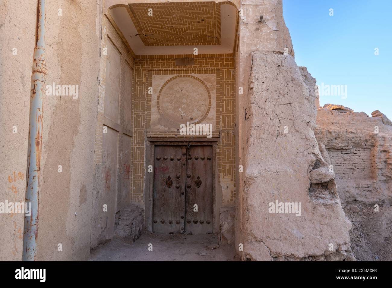 Traditional adobe building with exquisite and unique wooden doors. It ...