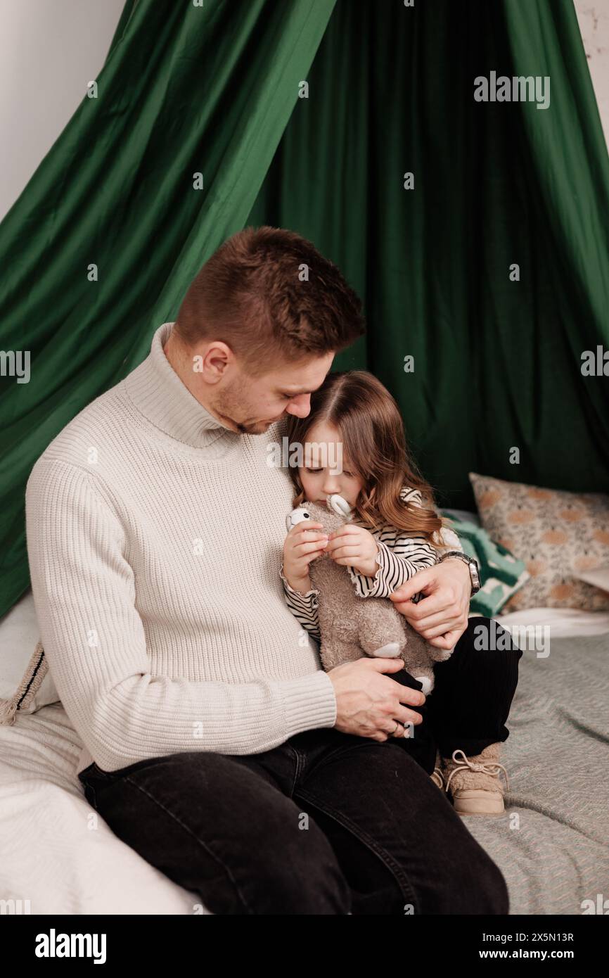 Happy Father's Day. Young daddy soft embraces his adorable little child ...