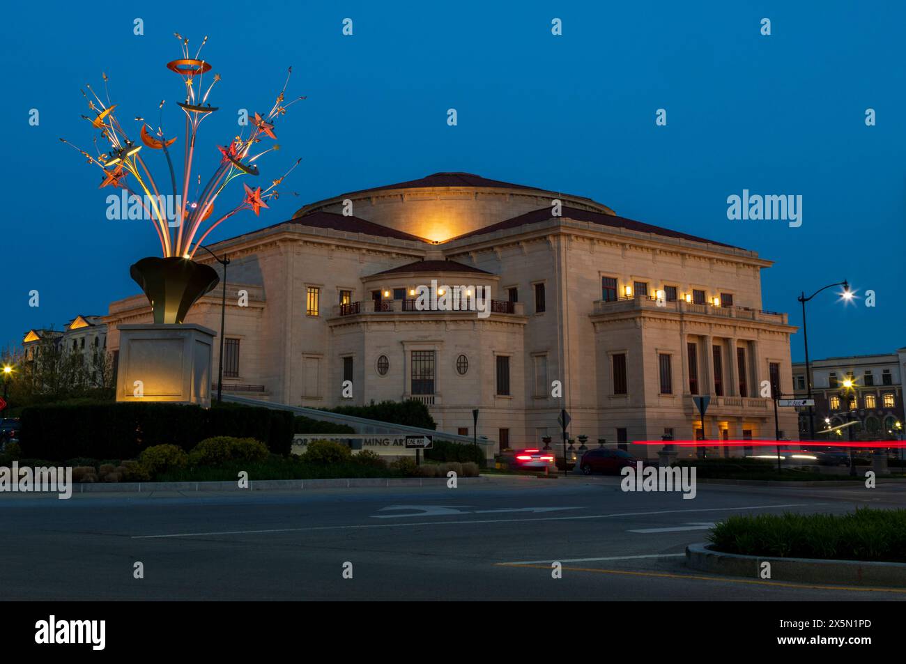 USA, Indiana, Carmel. The Palladium Concert Hall and sculpture at dusk ...