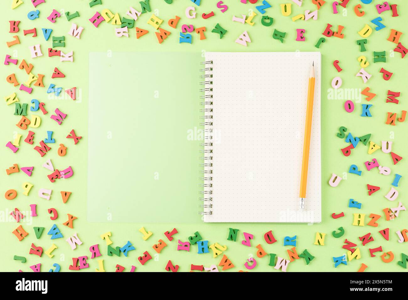 Open notepad with wooden alphabet Stock Photo - Alamy