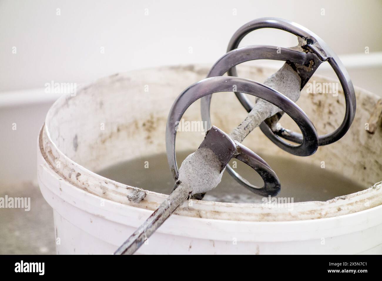 Stucco mixer laid on a white bucket ready to mix a mixture Stock Photo ...
