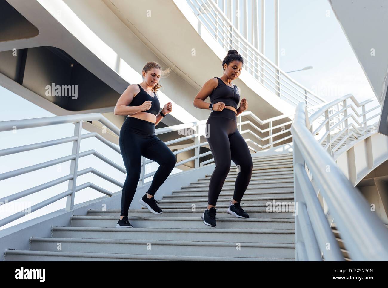 Two female friends with different body types wearing black sportswear ...