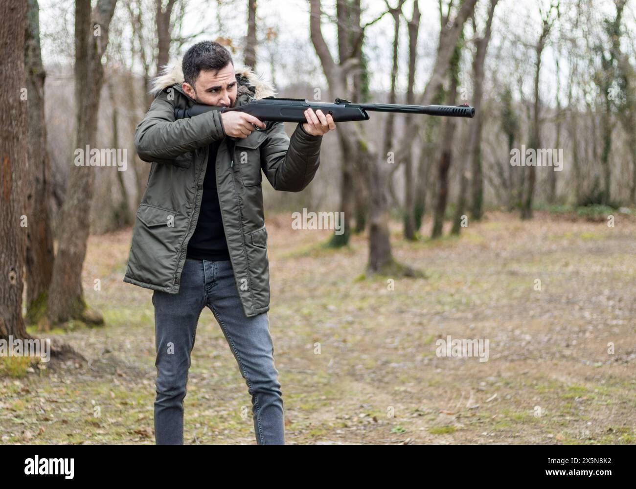 Young man shoots rifle in hi-res stock photography and images - Alamy