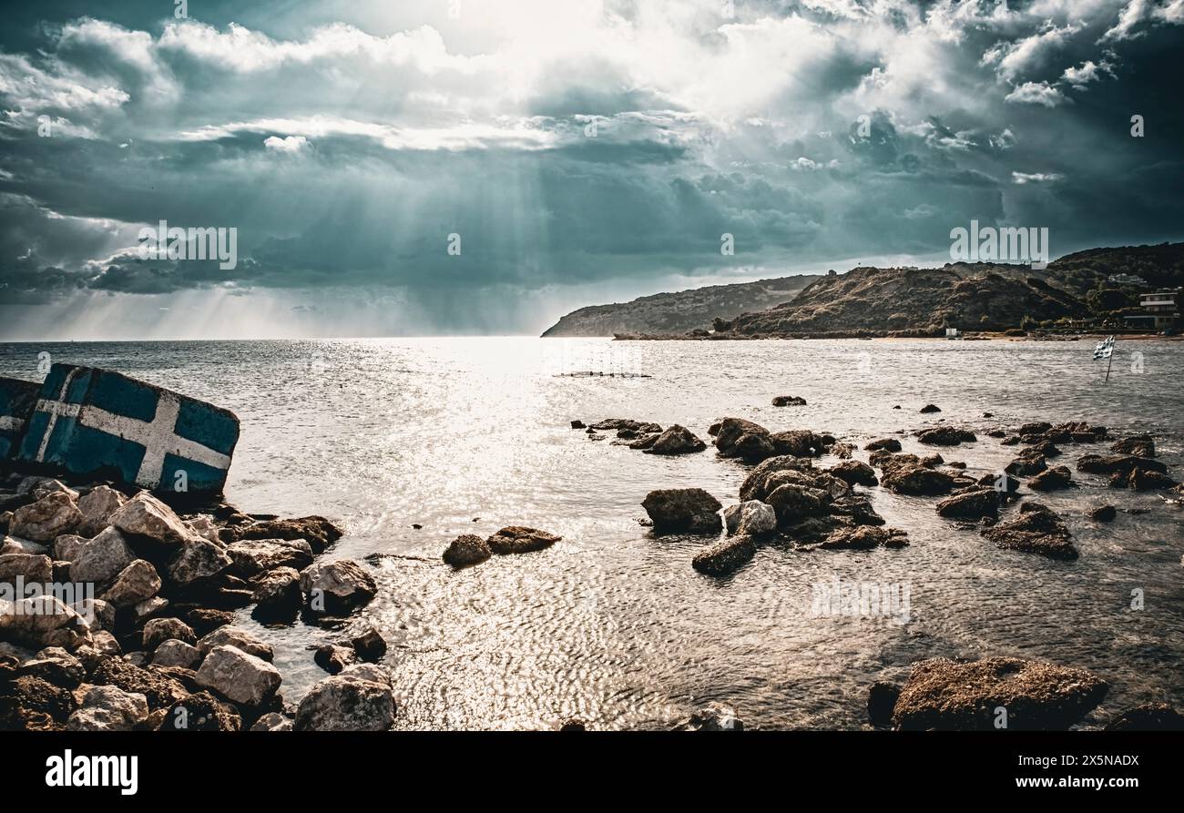 View over the coast of Rhodes. Storm clouds, sun rays, boulders, Greece ...