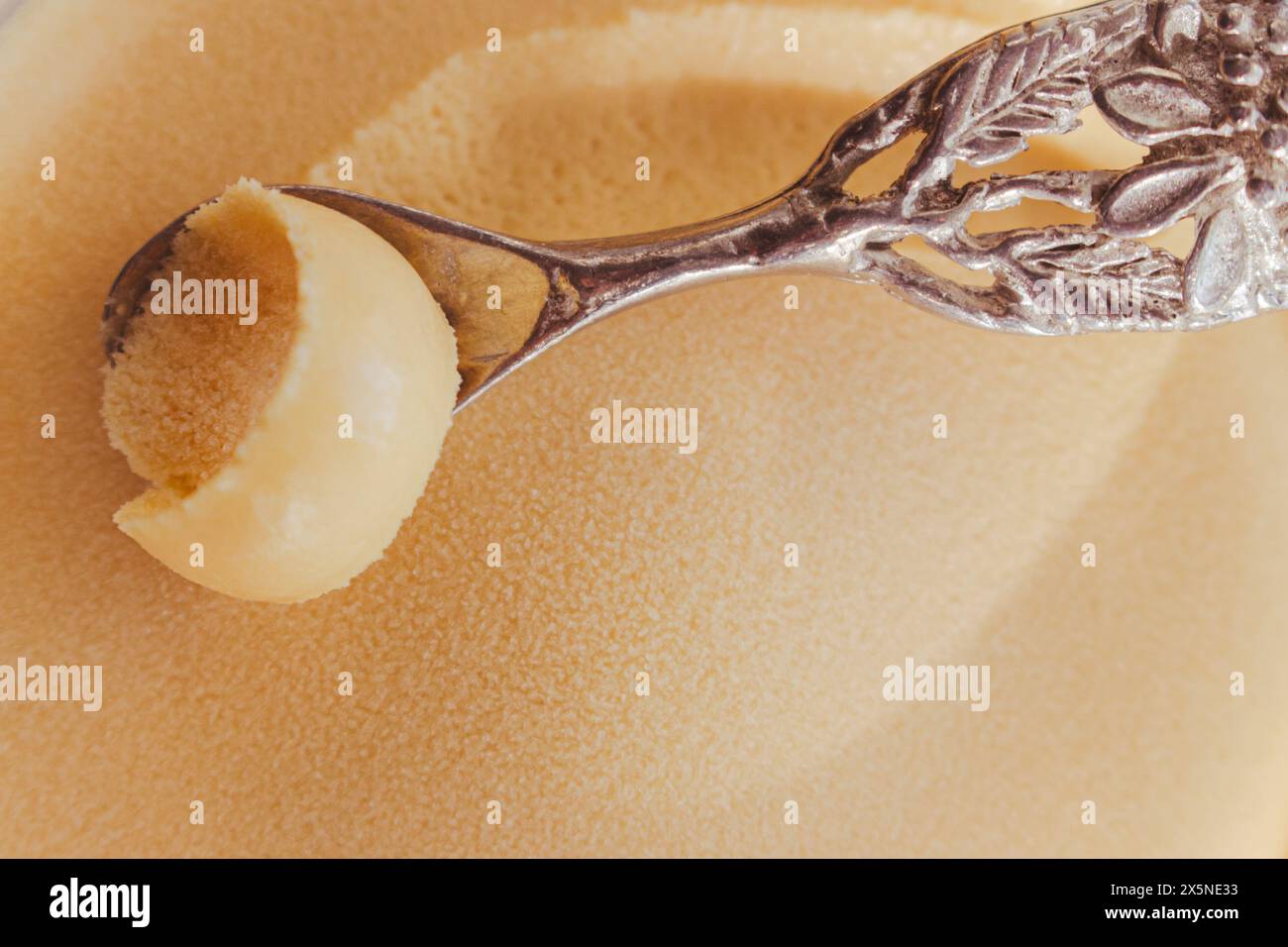 Vanilla ice cream with silver spoon. Ice cream texture. Frozen creamy dessert. Gelato isolated ...