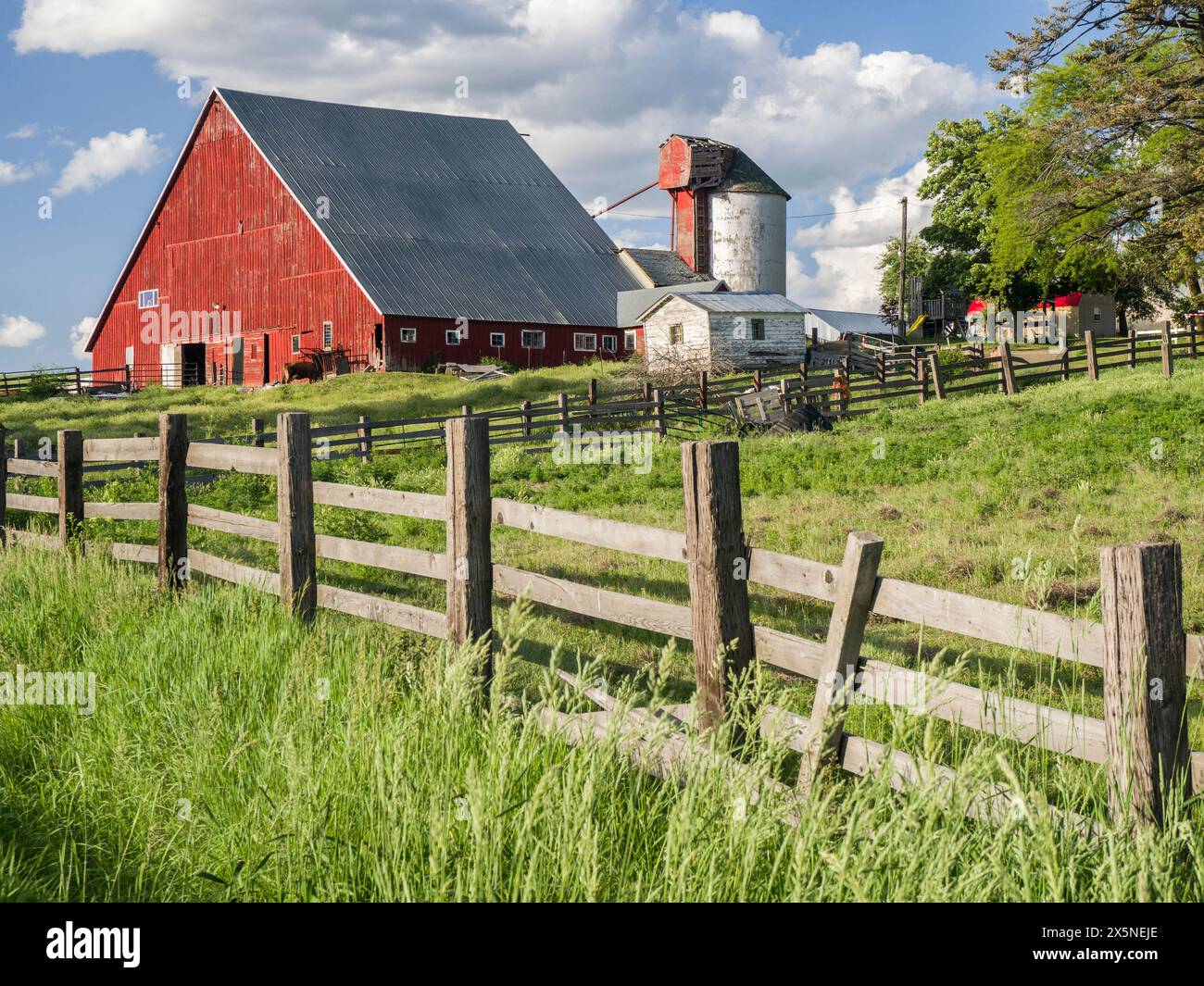 USA, Washington State, Palouse. Old fence line leading to a red barn ...