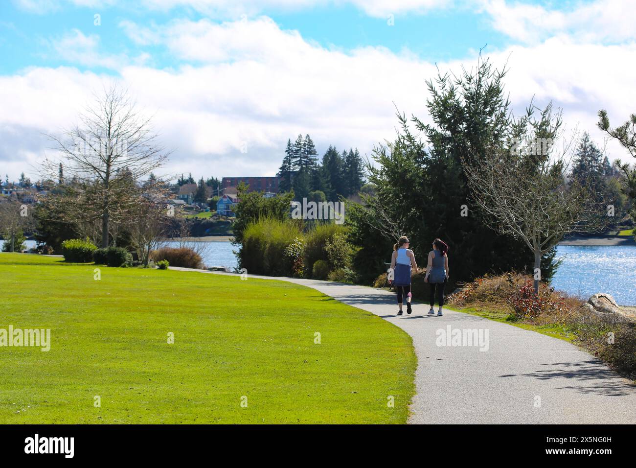Bremerton, Washington State, USA. Two women power walk along a path at ...