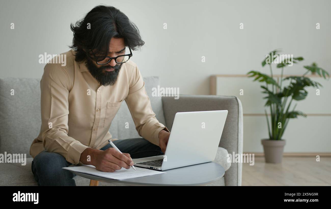 Arabian Indian muslim man guy businessman write notes papers paperwork ...