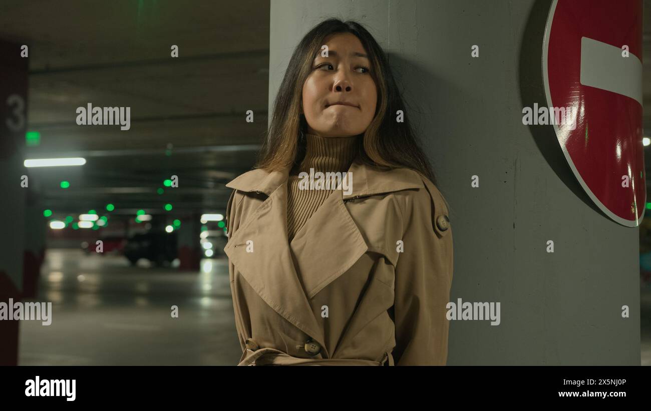 Frightened Asian ethnic chinese korean woman hiding from danger pursuit ...