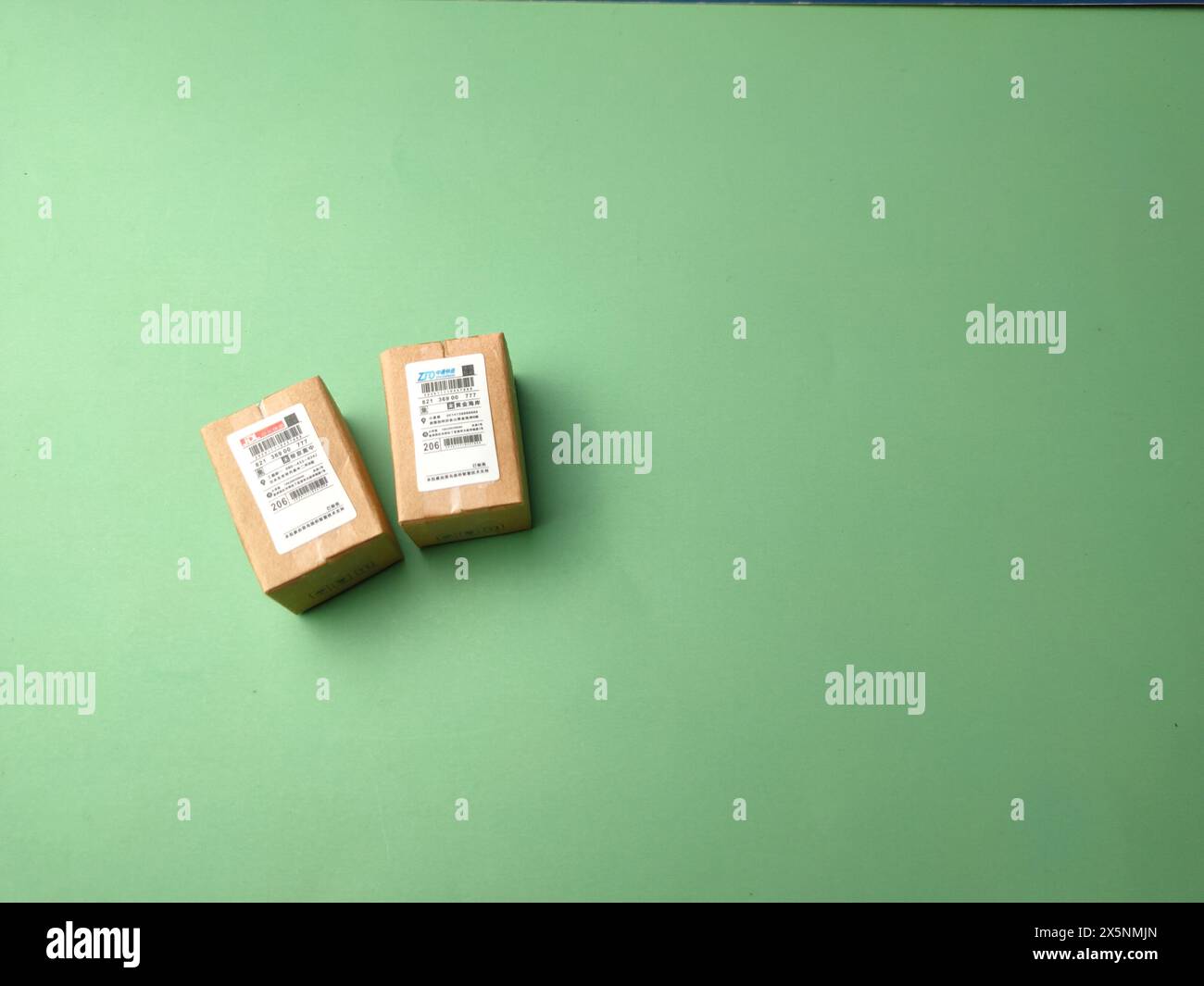 Top view.Miniature Mini Express Blind Box on a green background with ...