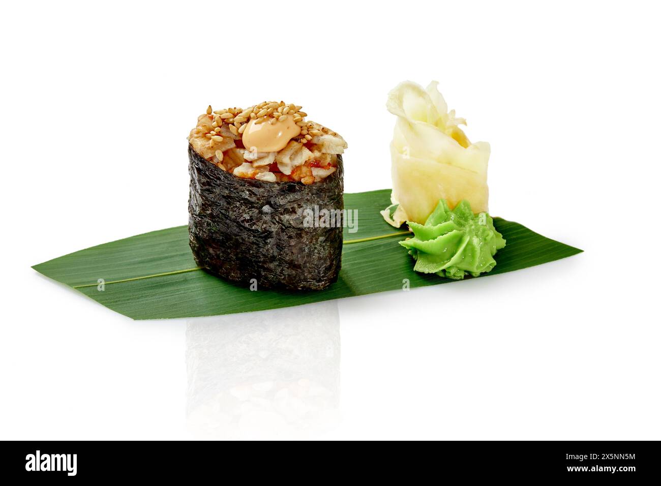Gunkan maki sushi with eel seasoned with spicy sauce and sesame, presented with wasabi and ...