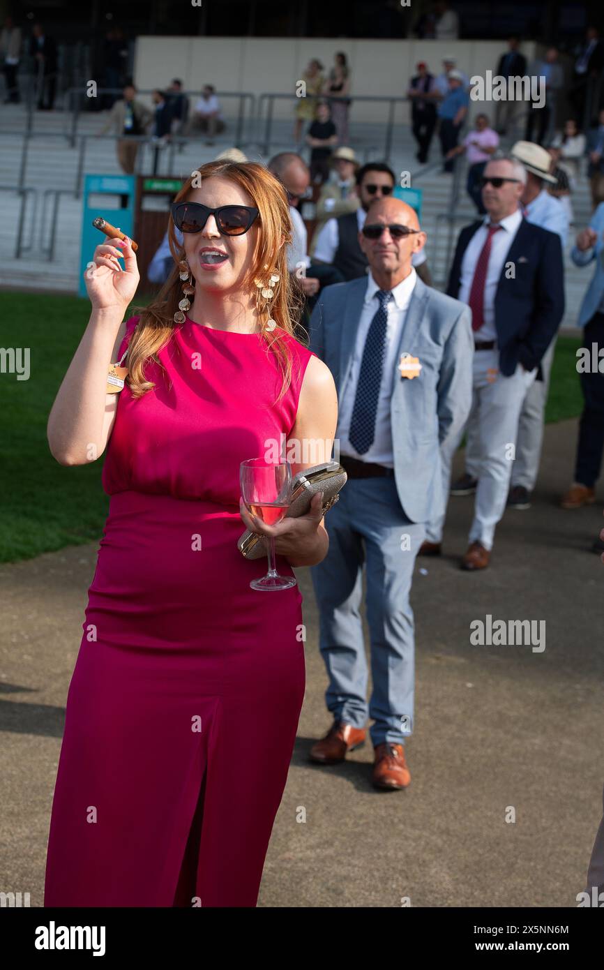 Ascot, Berkshire, UK. 10th May, 2024. A woman smokes a cigar at Ascot ...