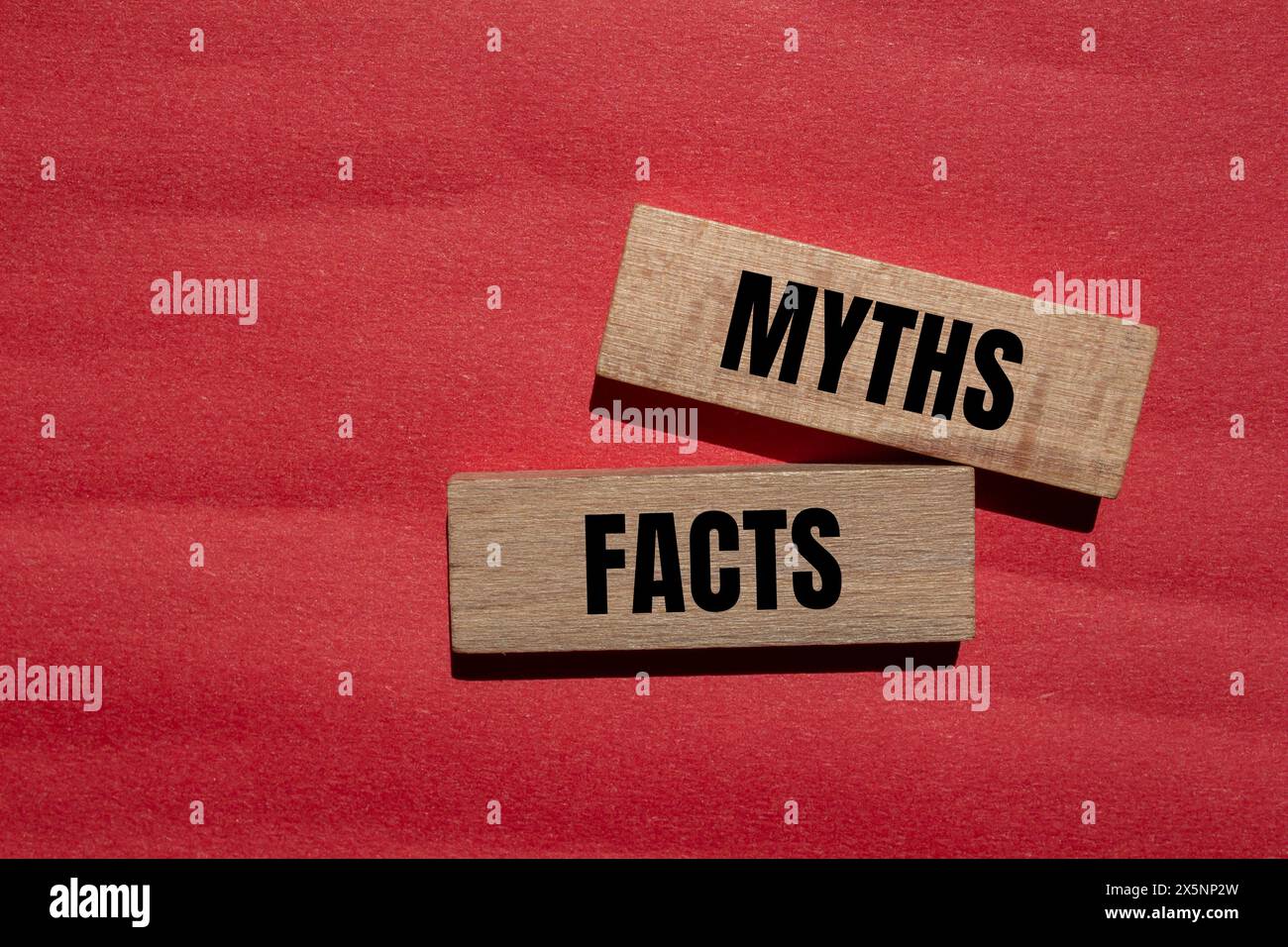 Myths and facts words written on wooden blocks with red background ... Myths and facts words written on wooden blocks with red background ...