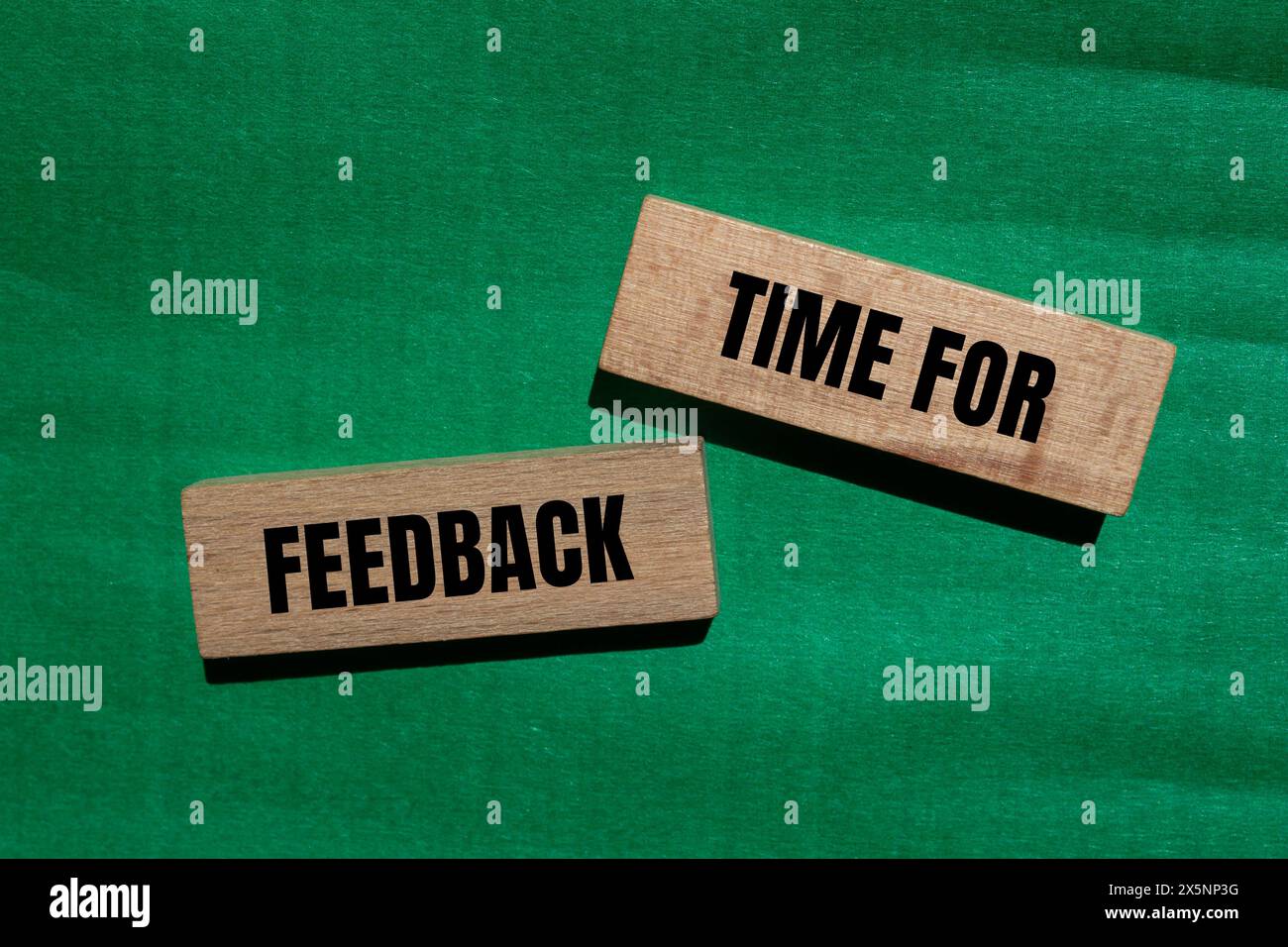 Time for feedback words written on wooden blocks with green background ...