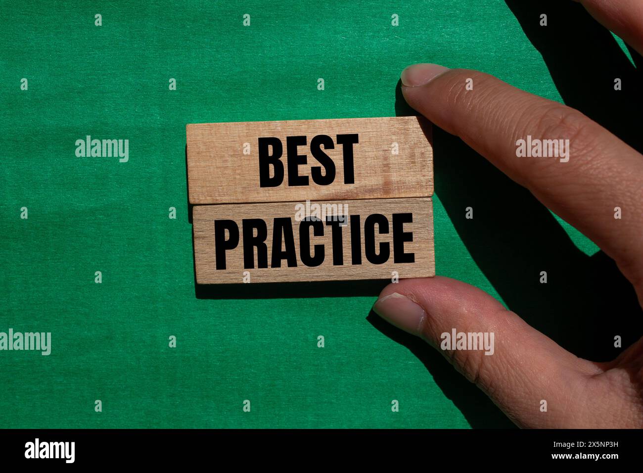 Best practice words written on wooden blocks with green background ...
