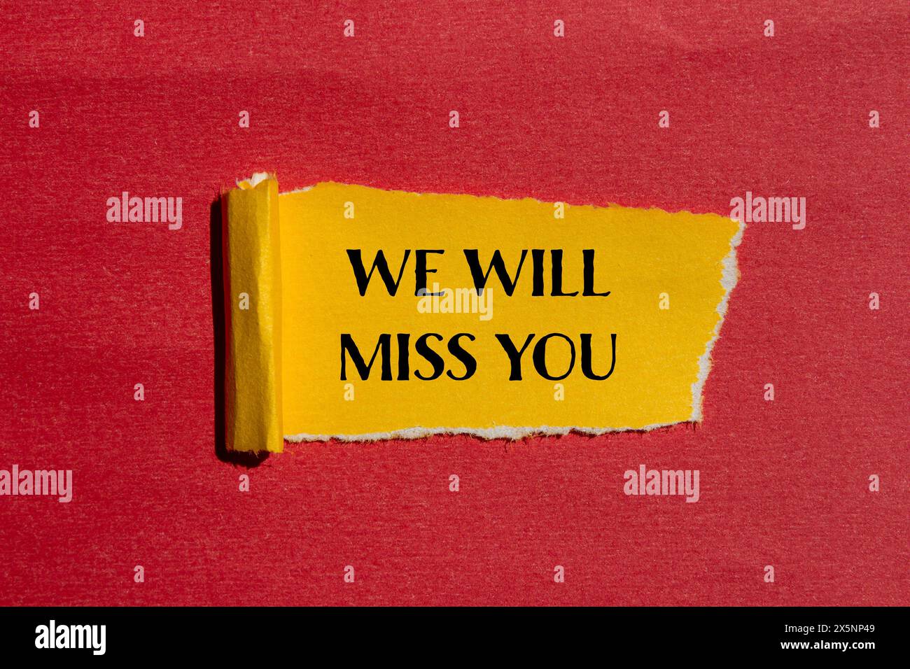 We will miss you words written on torn yellow paper with red background ...