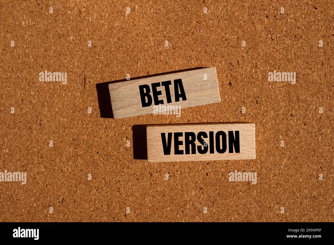 Beta version words written on wooden blocks with brown background ...