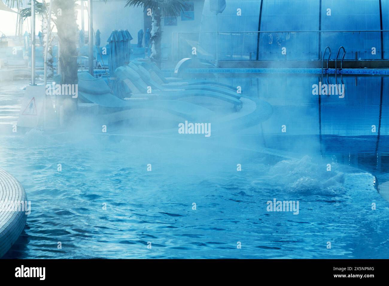 Hot spring, pool with hot mineral water. Steam over the outdoor pool in ...