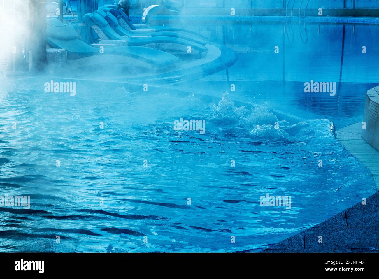 Hot spring, pool with hot mineral water. Steam over the outdoor pool in ...