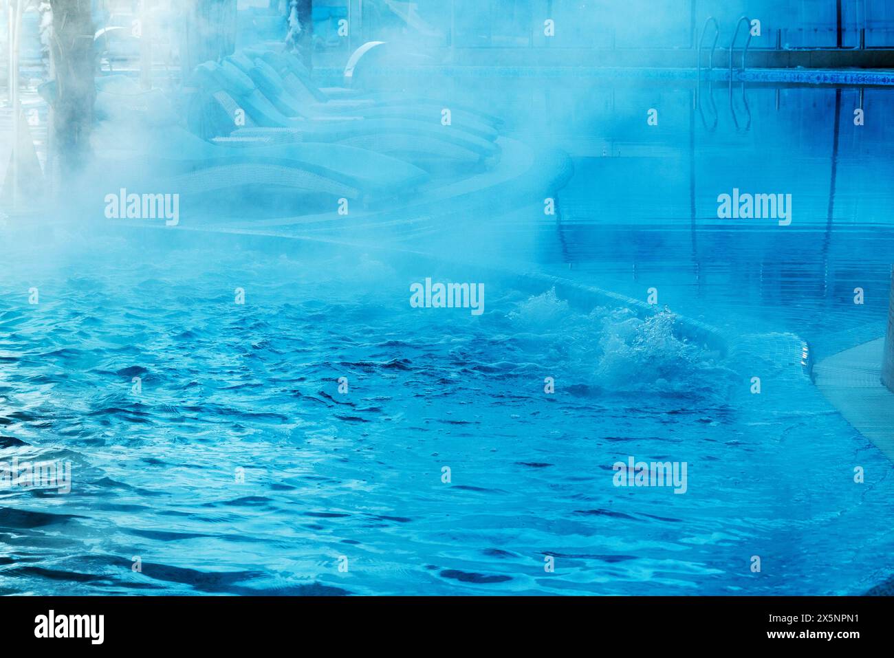 Hot spring, pool with hot mineral water. Steam over the outdoor pool in ...