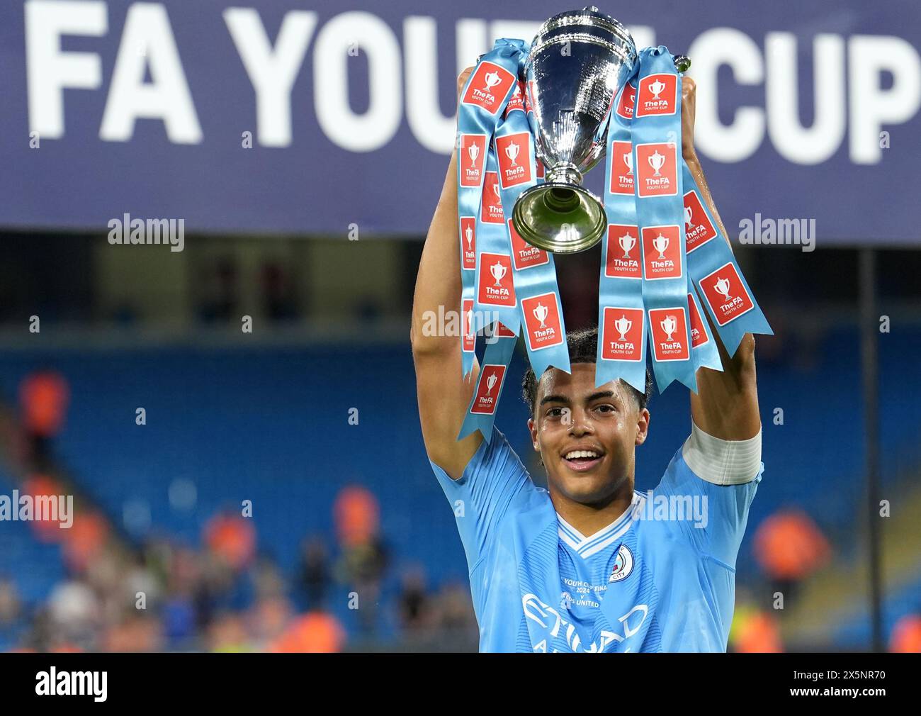 Manchester City's Jahmai Simpson-Pusey lifts the trophy following the ...