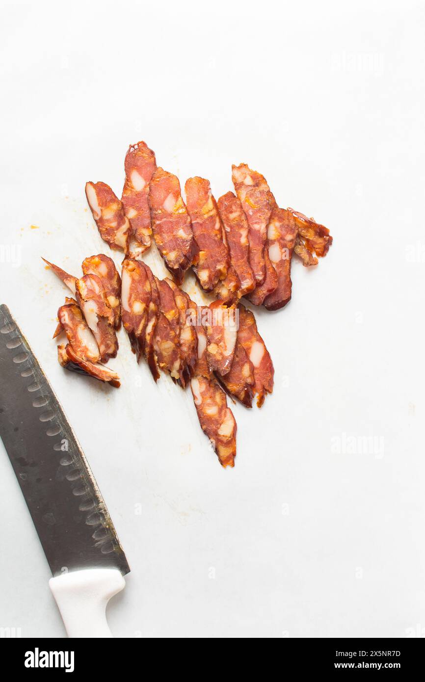 Top view of sliced chinese sausage on a white plate, overhead view of ...