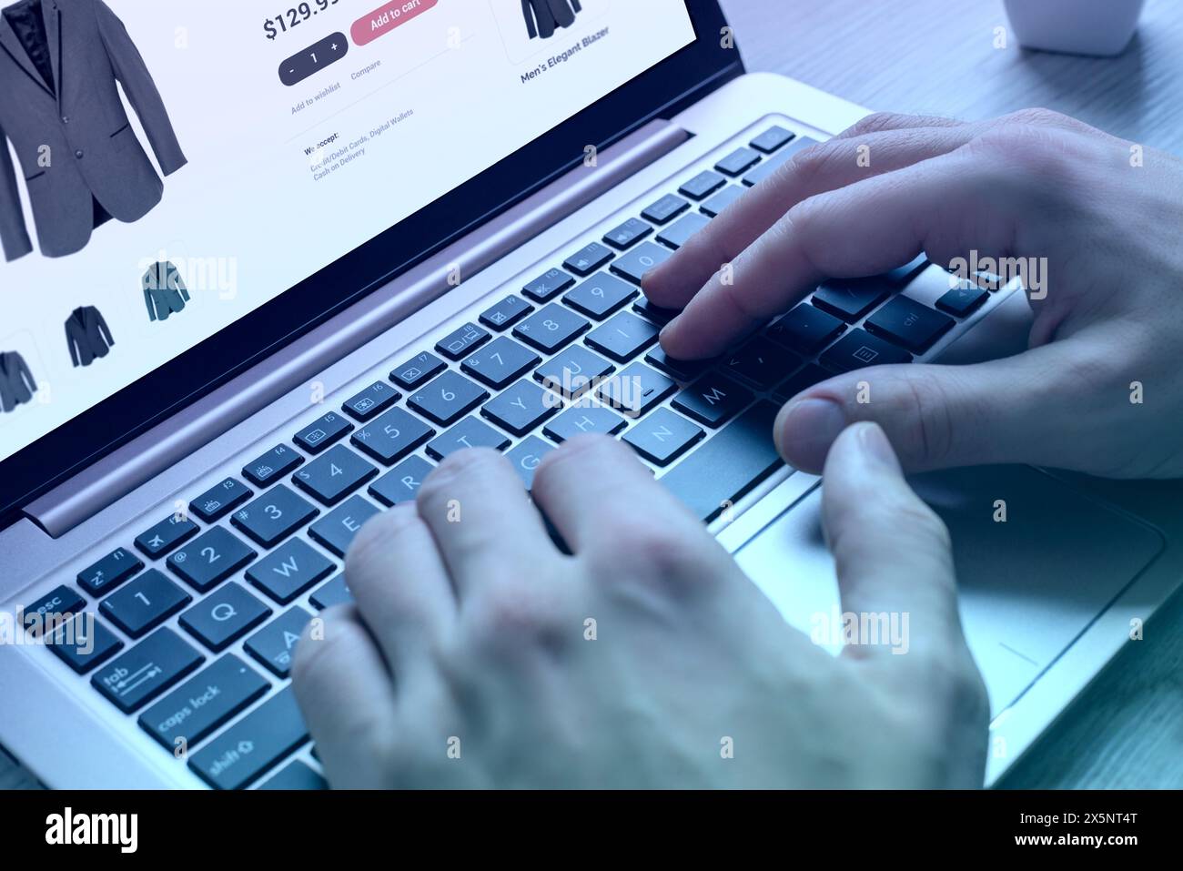 Shopping for clothes online with a laptop. E-commerce interface concept ...