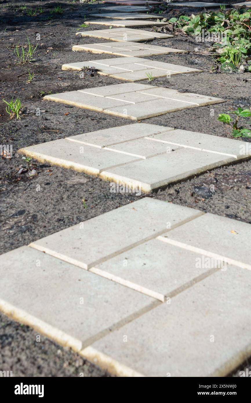 Perspective of concrete paving slabs on cottage garden ground. Cottage ...