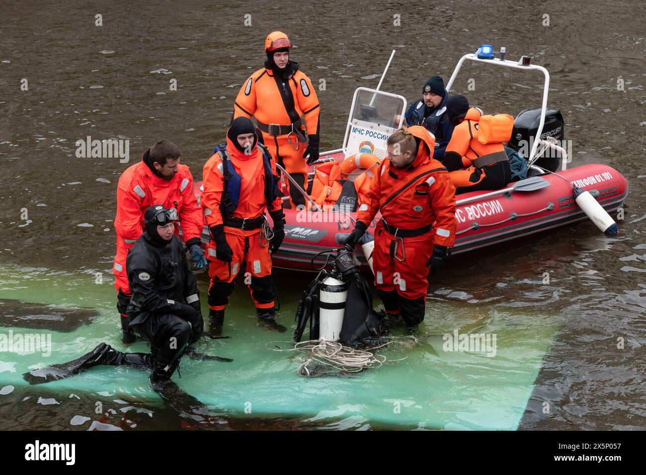 Rescuers are working at the site where a bus with passengers fell into ...