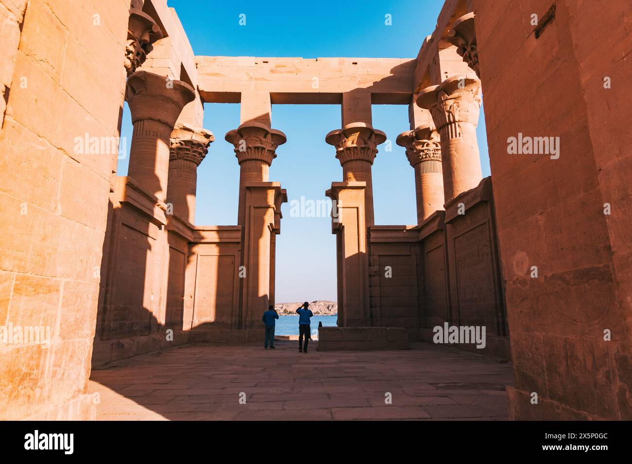 Toursits photograph giant columns at the Philae temple complex, Aswan ...