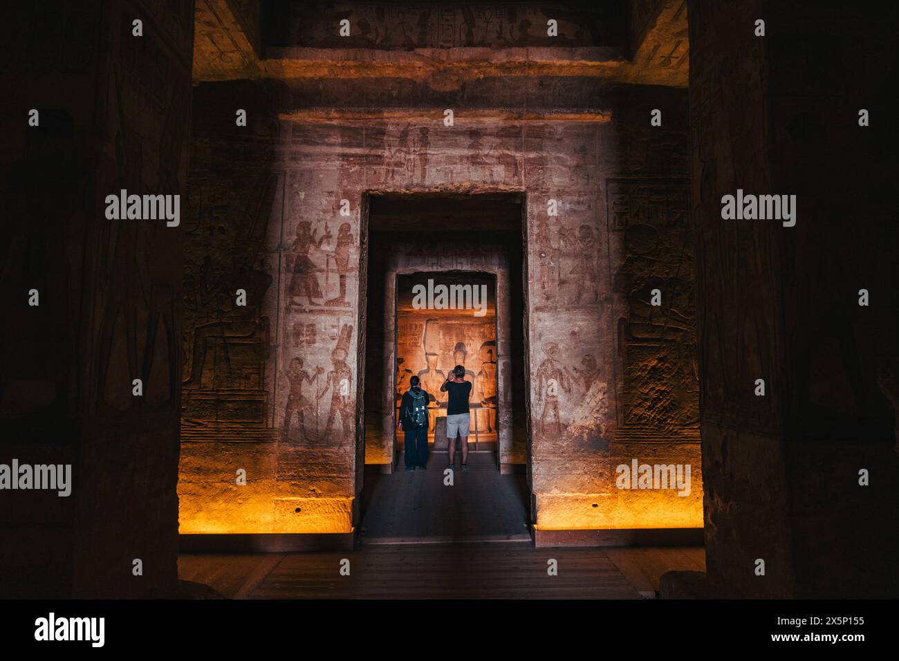 Tourists examine rock carving inside the Great Temple of Abu Simbel in ...