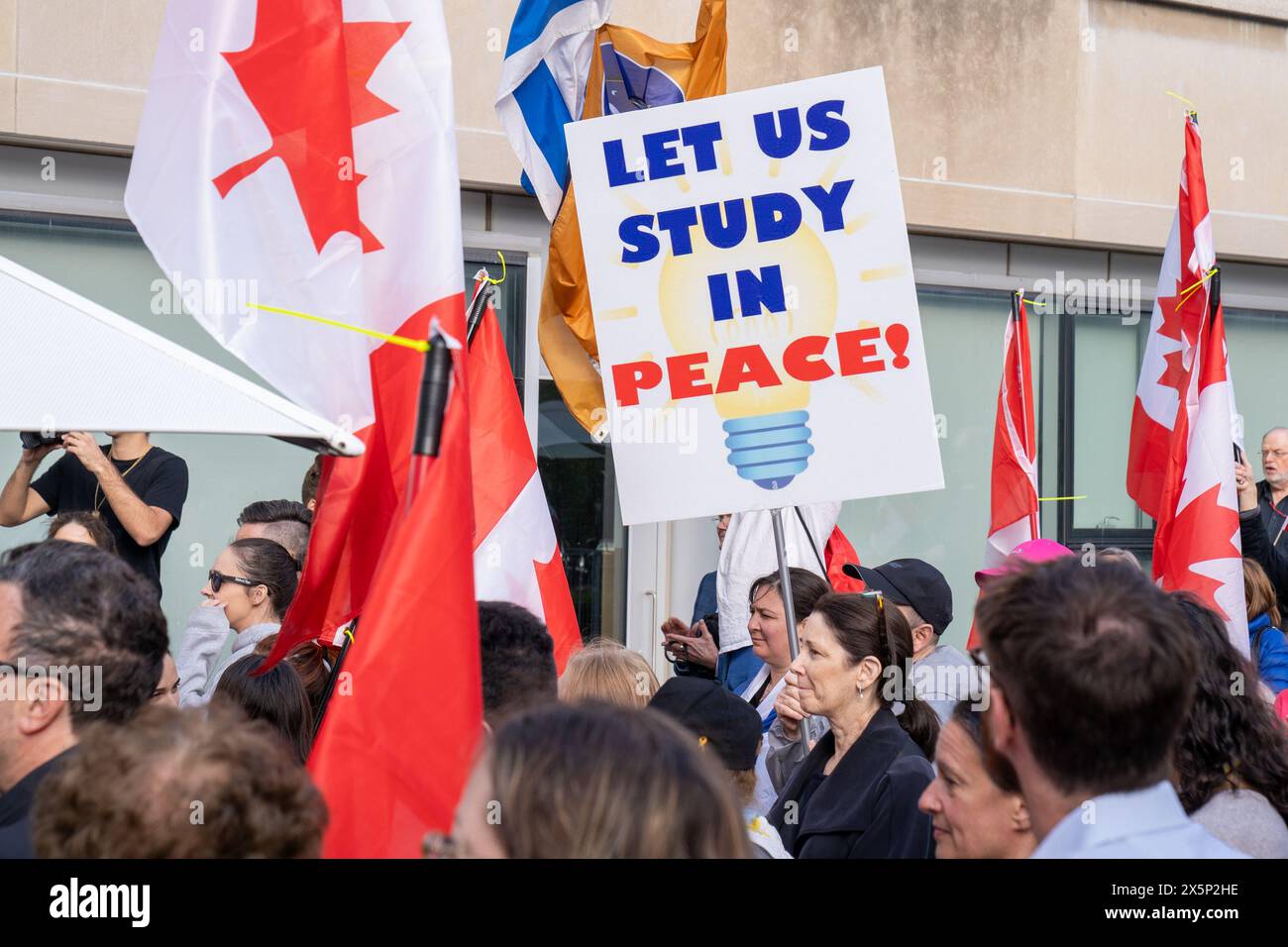 A student holds a placard saying Let us study in peace during the rally ...