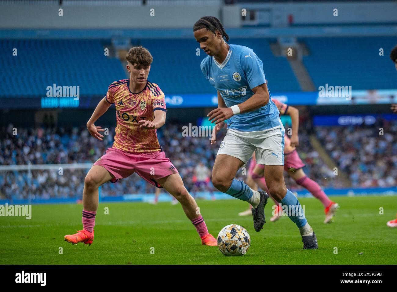 Divine Mukasa #10 of Manchester City challenged by the opponent during ...