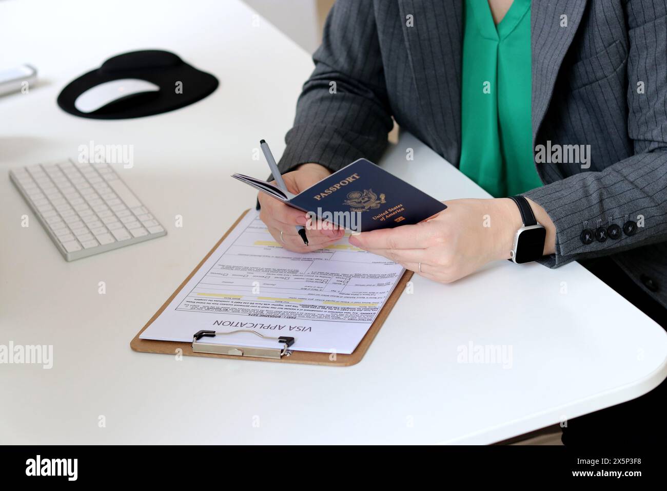 Top view close up of a woman filling out visa application documents ...