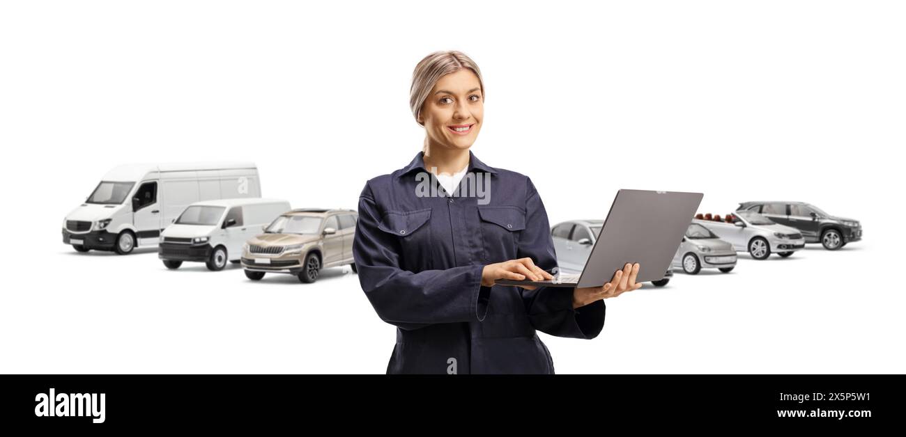 Female worker in a navy blue overall uniform with a laptop computer in ...