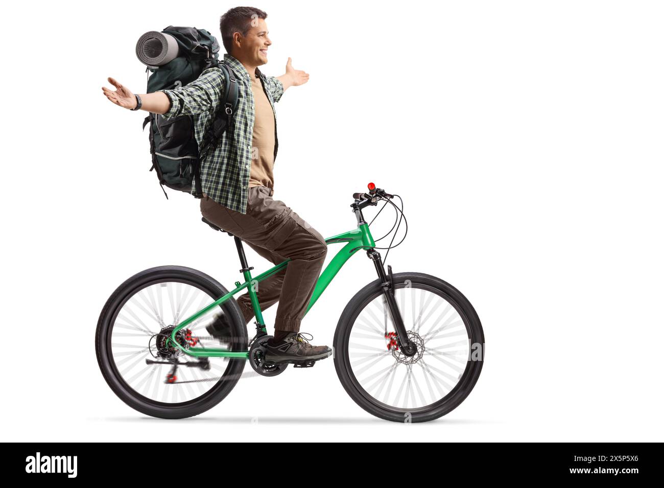 Full length profile shot of a young man with a backpack riding a ...