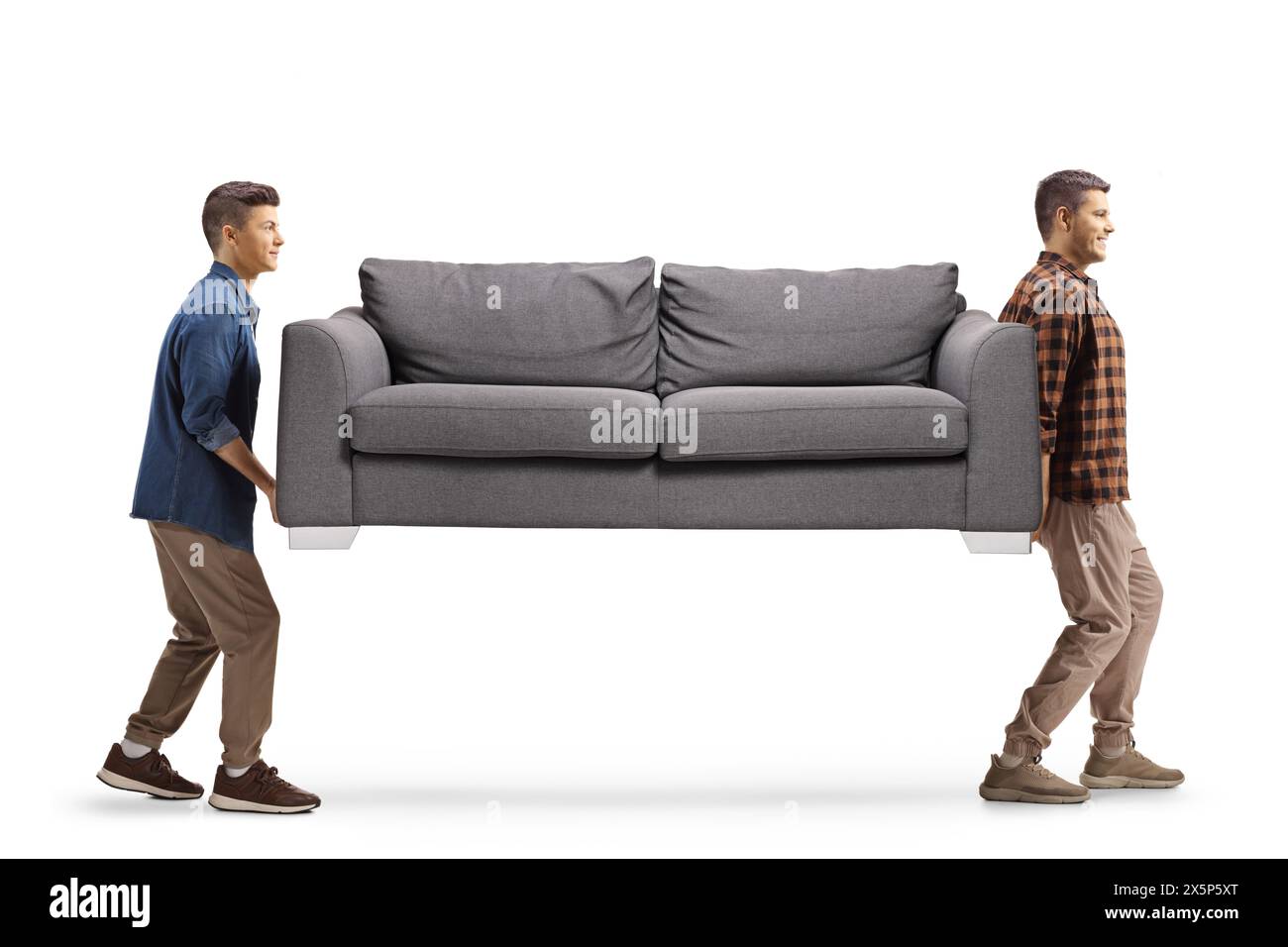 Young men carrying a gray sofa isolated on white background Stock Photo ...