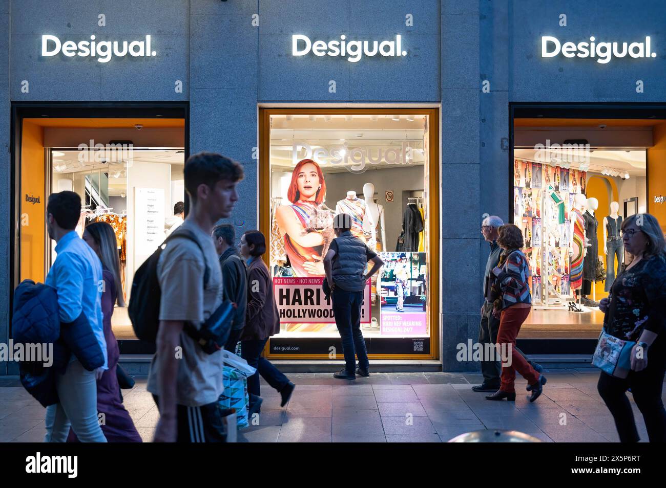 Pedestrians walk past the Spanish clothing brand Desigual store in ...