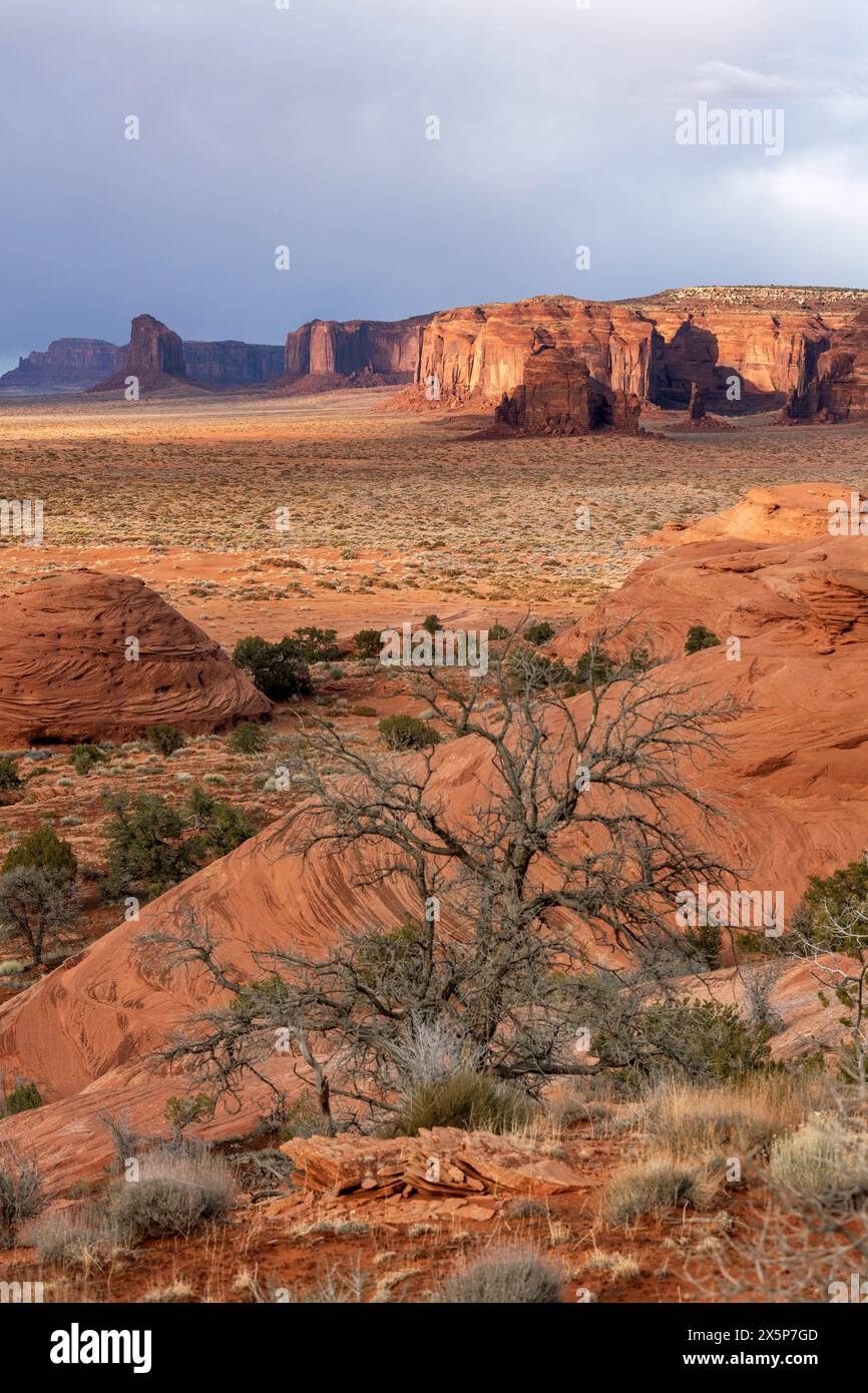 A hike into a remote area of Monument Valley Arizona during dusk shows ...