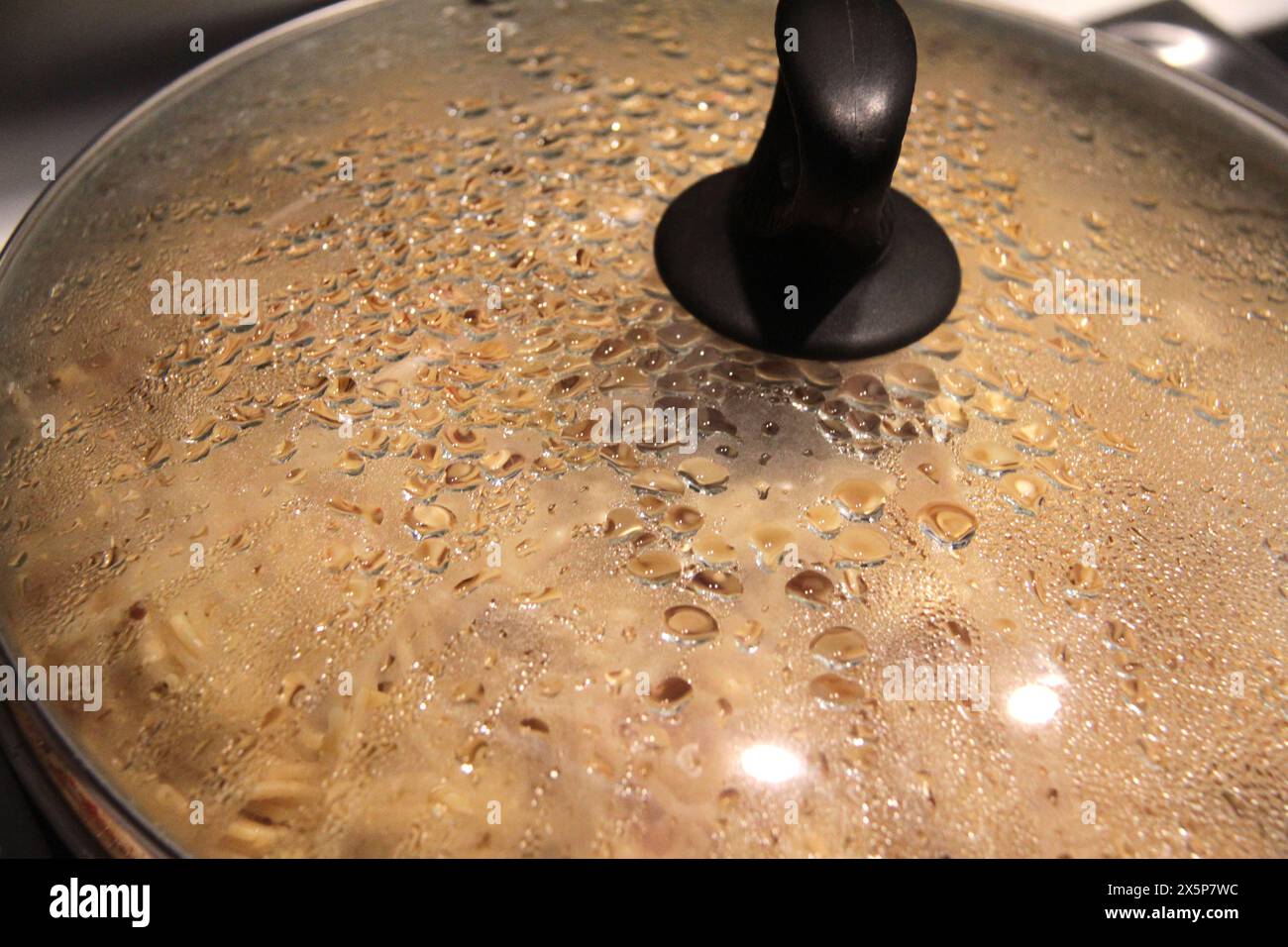 Condensation formed under a glass lid during cooking Stock Photo - Alamy