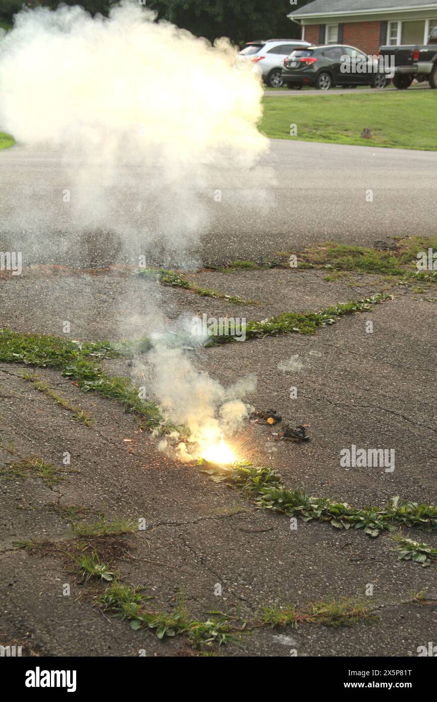 Burning firecrackers on a driveway of a private house in the U.S.A ...