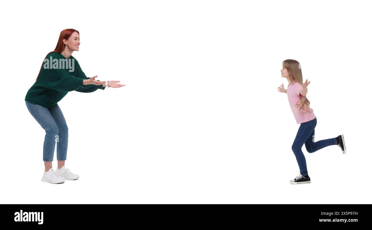 Happy girl running towards her mother on white background Stock Photo ...