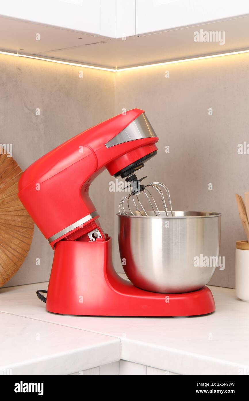 Modern red stand mixer on white countertop in kitchen Stock Photo - Alamy