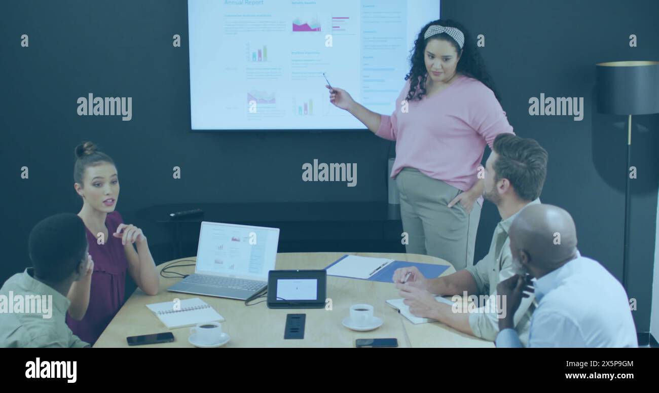 Diverse team discussing business graphs, biracial team leader pointing ...