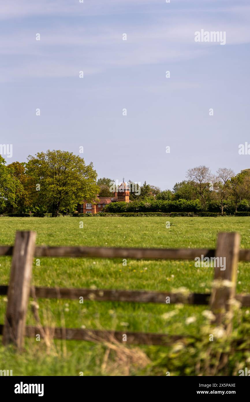 Scenic rural landscape with a charming house peeking through lush ...