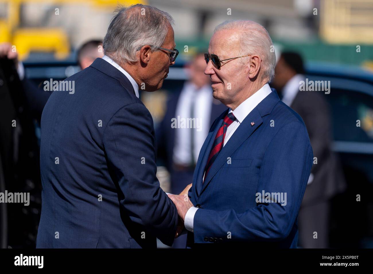 Washington Gov. Jay Inslee, left, greets President Joe Biden as he ...