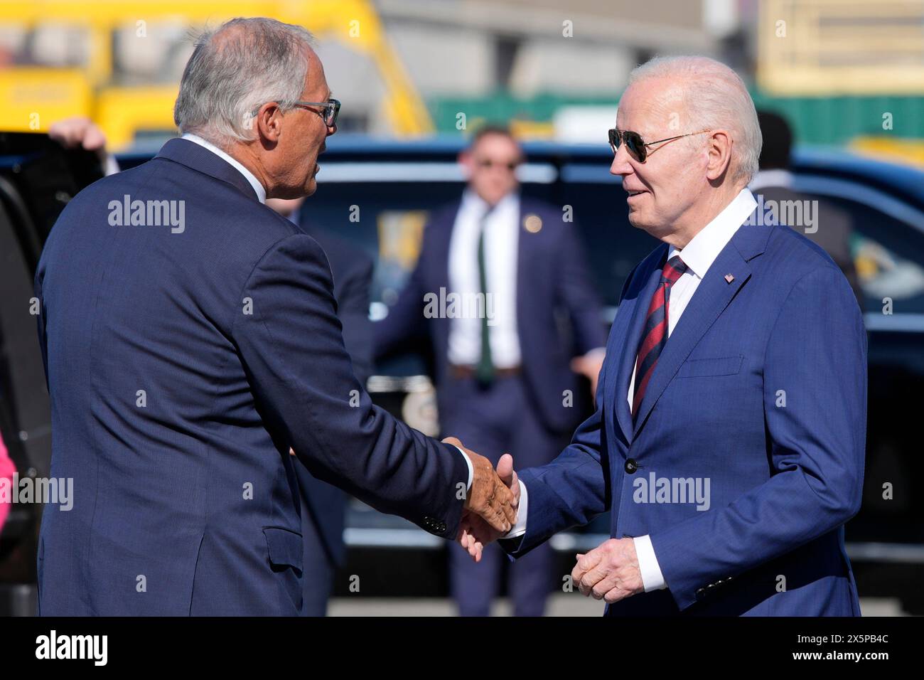 Washington Gov. Jay Inslee, left, greets President Joe Biden as he ...