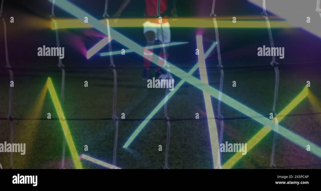 Neon light stripes against mid section of male soccer player taking a ...