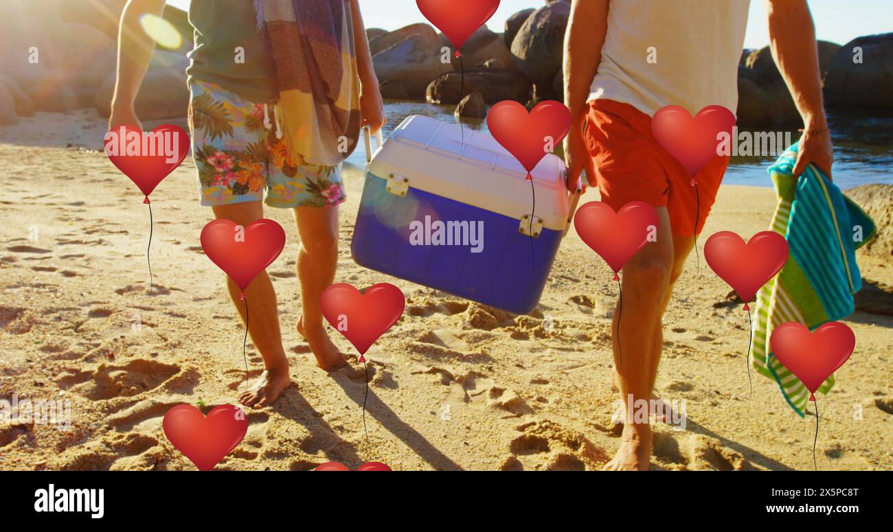 Image of heart shaped balloons moving up over caucasian male friends ...